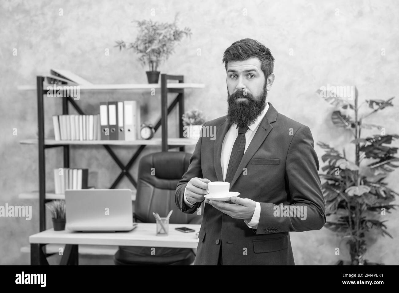 amazed brutal ceo in businesslike suit hold morning coffee cup at the ...