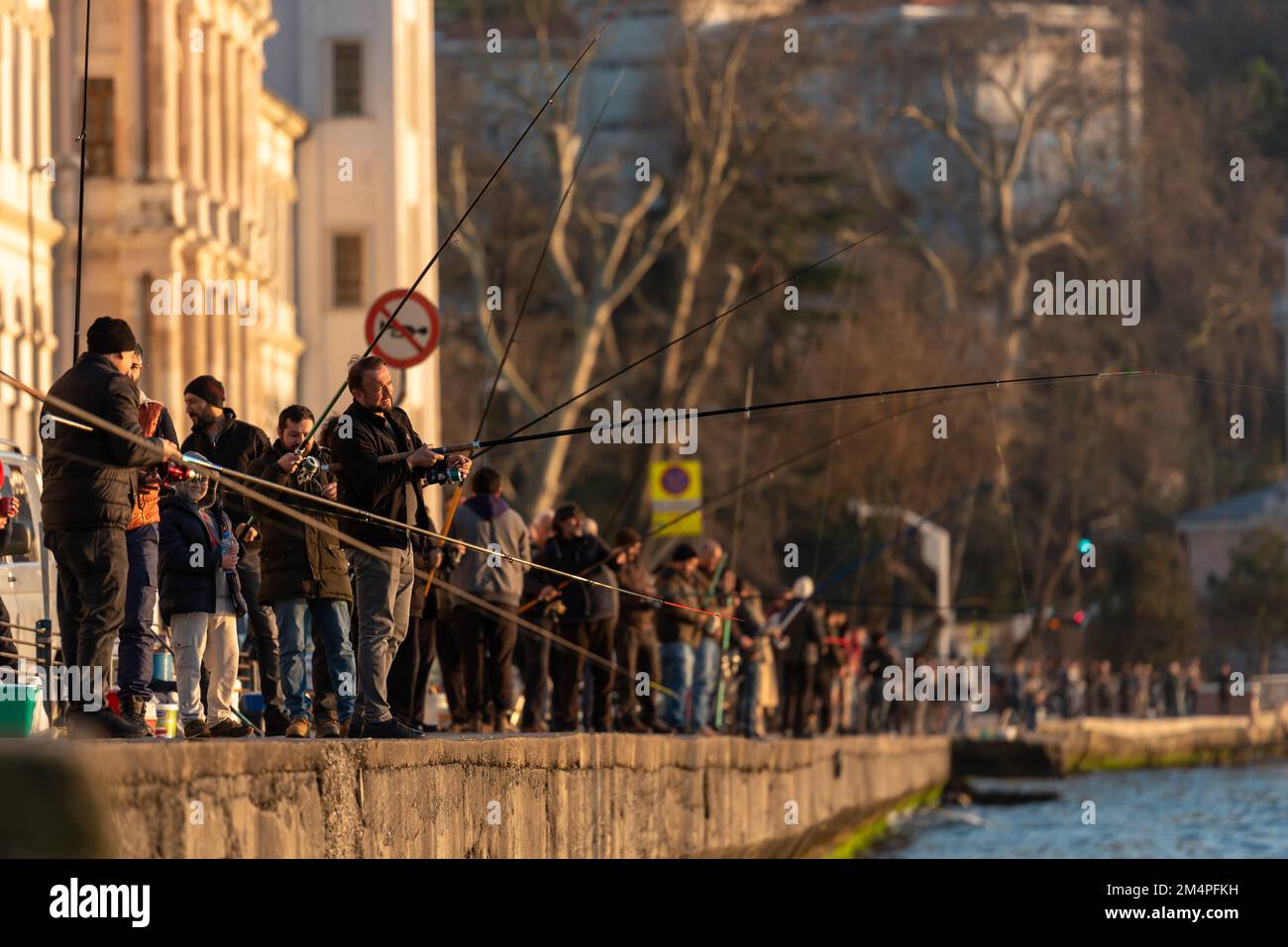 istanbul , turkey - 23 February 2020 : crowded group of people fishing ...