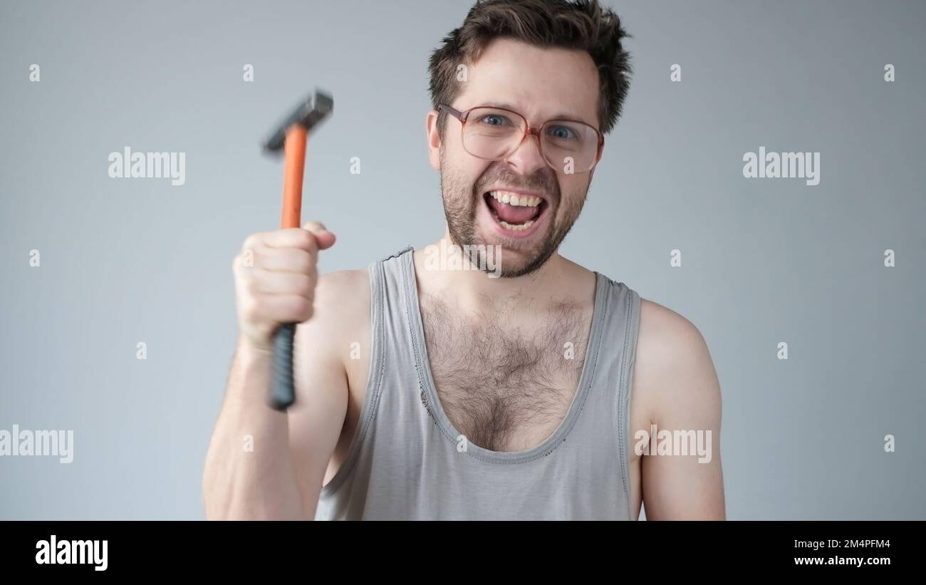 Mad repairman concept. Builder repairman, foreman holding hammer in ...