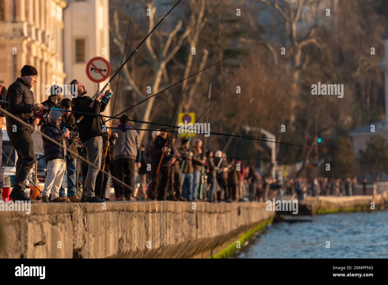 istanbul , turkey - 23 February 2020 : crowded group of people fishing ...