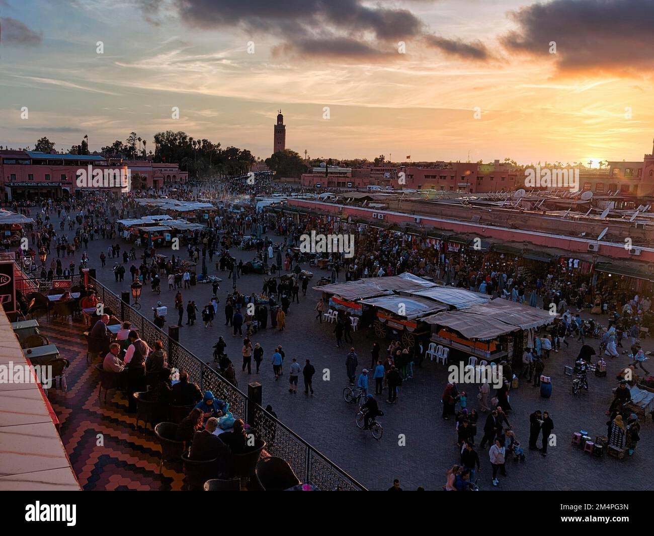 Panoramic view at dusk, crowds in the bustling marketplace Djemaa el ...