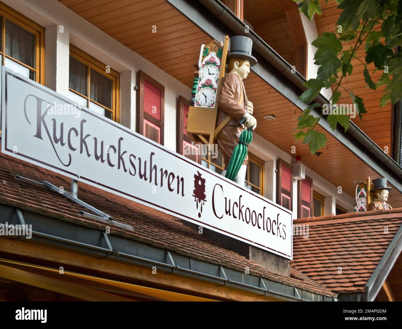 Clock carrier figure on a cuckoo clock shop in Titisee, Black Forest ...