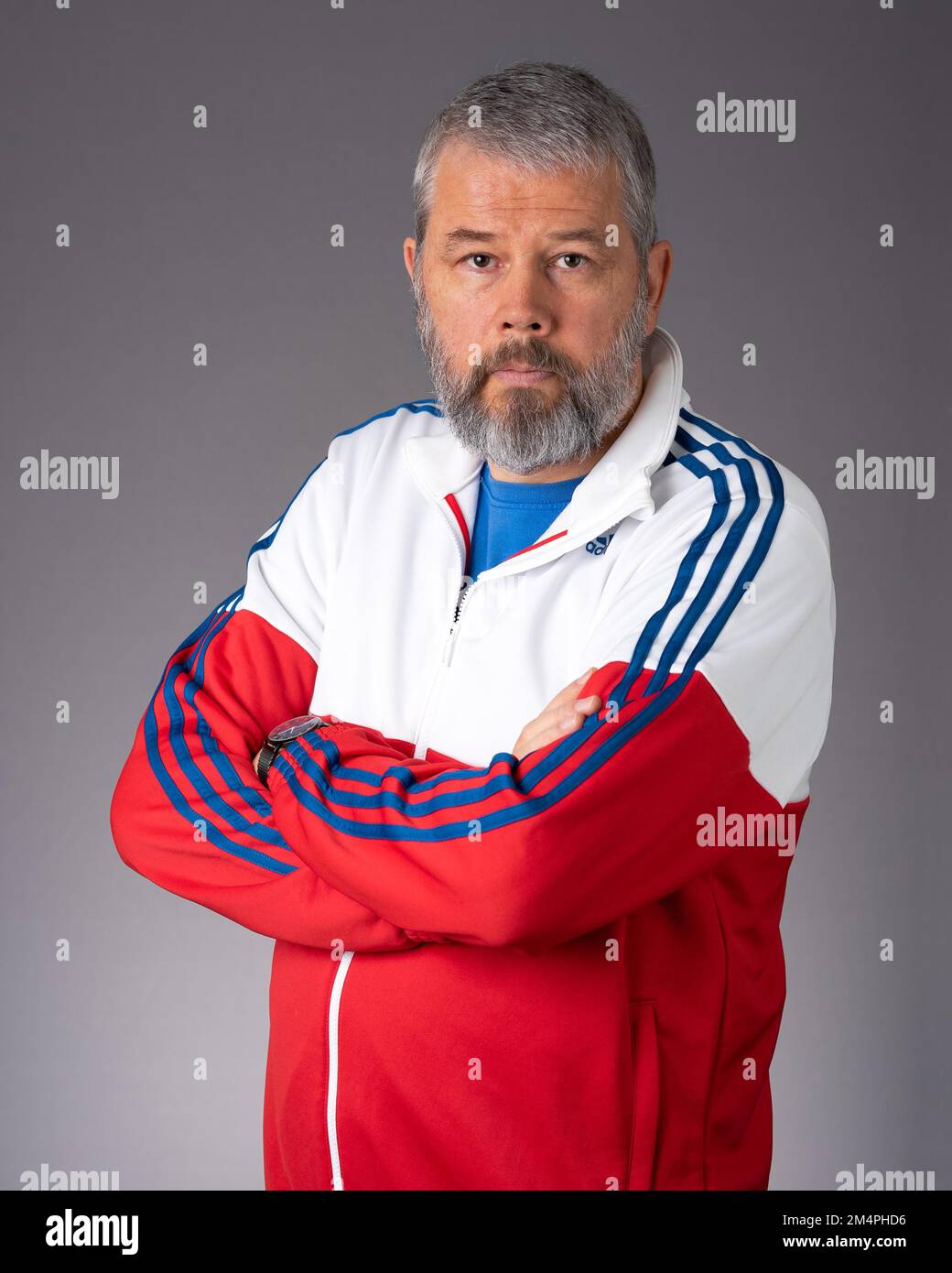 Man with full beard, 55 years old in trainer pose with folded arms ...