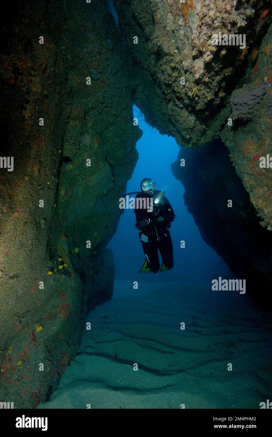Natural tunnel in lava reef formed after primeval volcanic eruption ...
