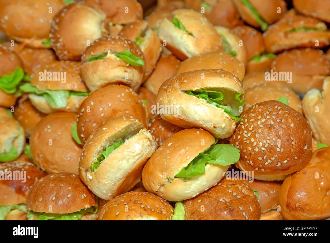 Large group of small breads stuffed with chicken and green lettuce ...