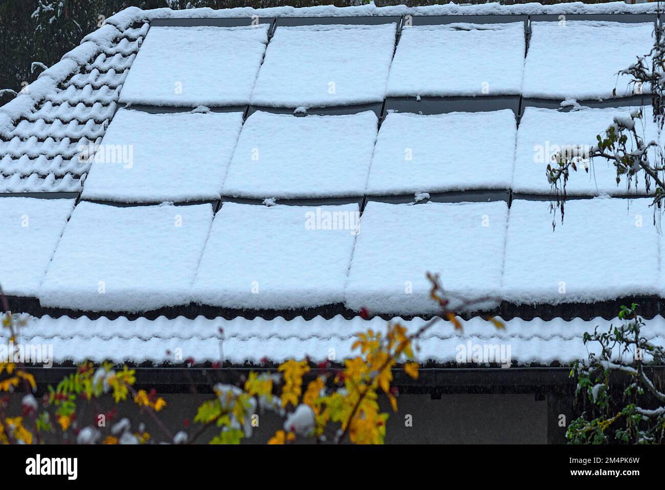 Snow-covered photovoltaic panels on a garage roof, Bavaria, Germany ...