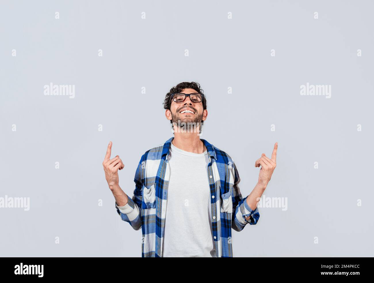 Smiling man in glasses pointing fingers up, People recommending ...