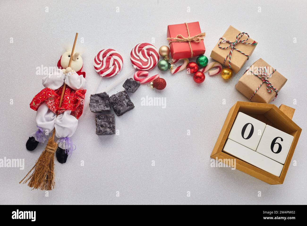 The Befana with sweet coal and candy on wooden background. Italian ...