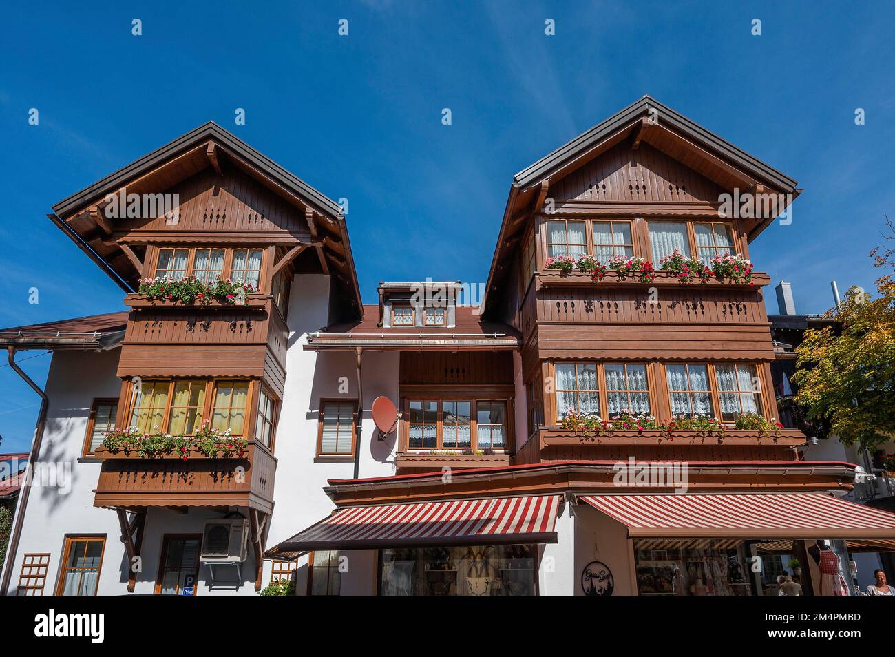 Classic wooden building with bay windows and floral decorations ...
