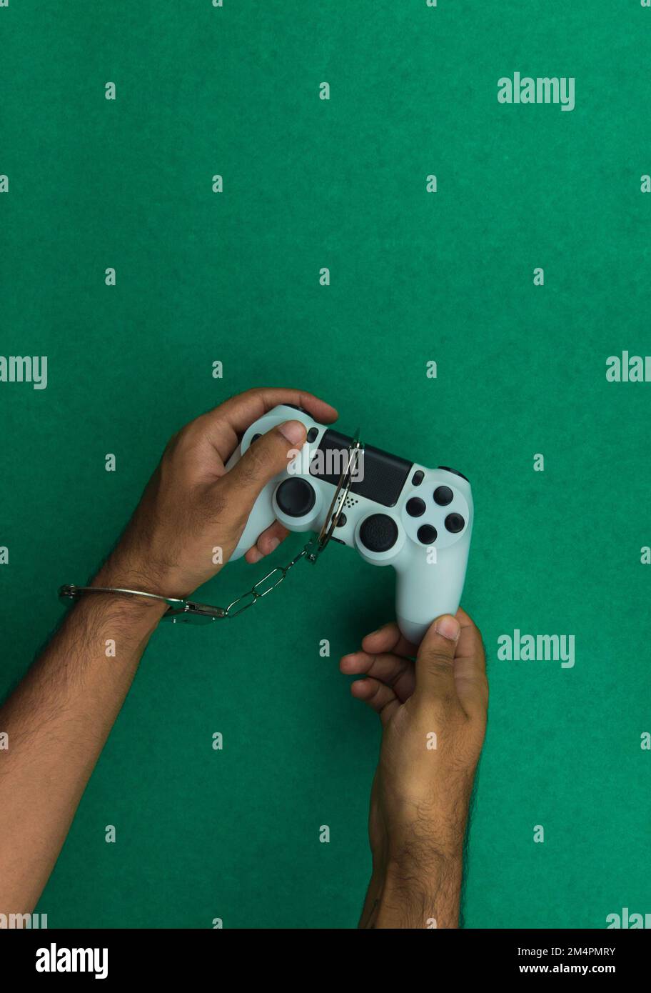 Video game joystick and handcuffs isolated. Addiction to games concept ...