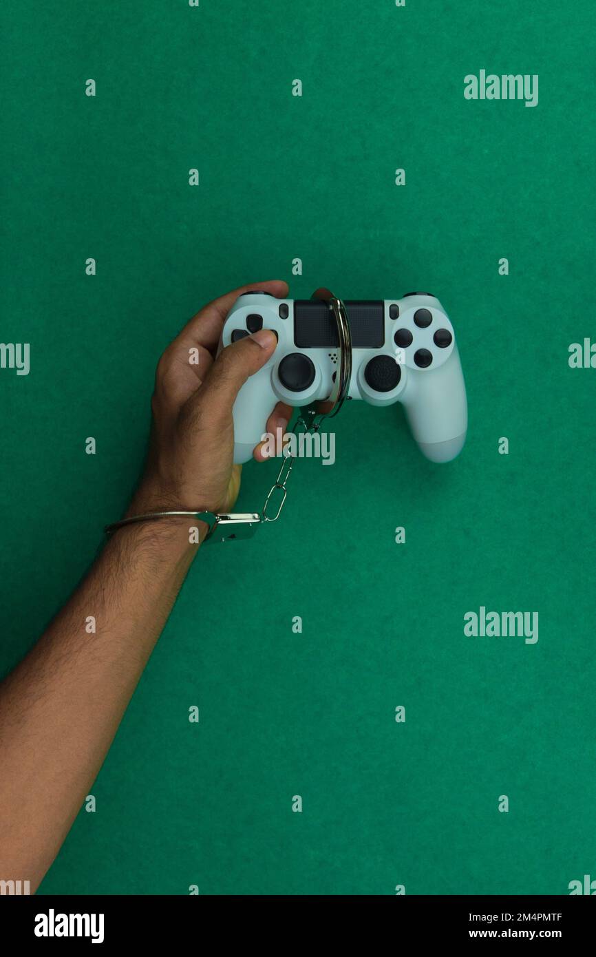 Video game joystick and handcuffs isolated. Addiction to games concept ...