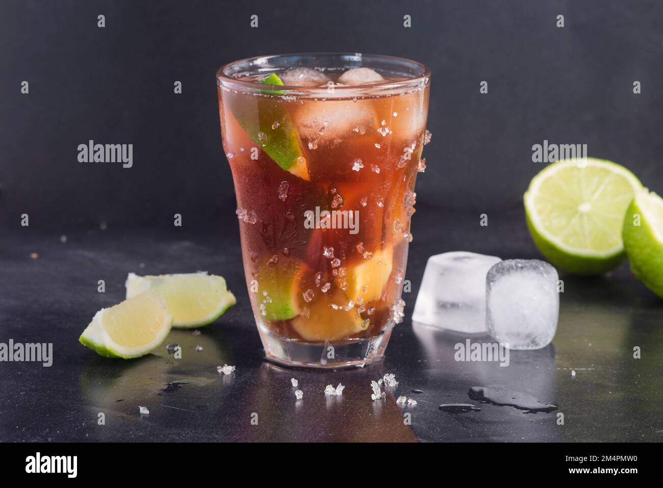 Rum cola cocktail on dark background Stock Photo - Alamy