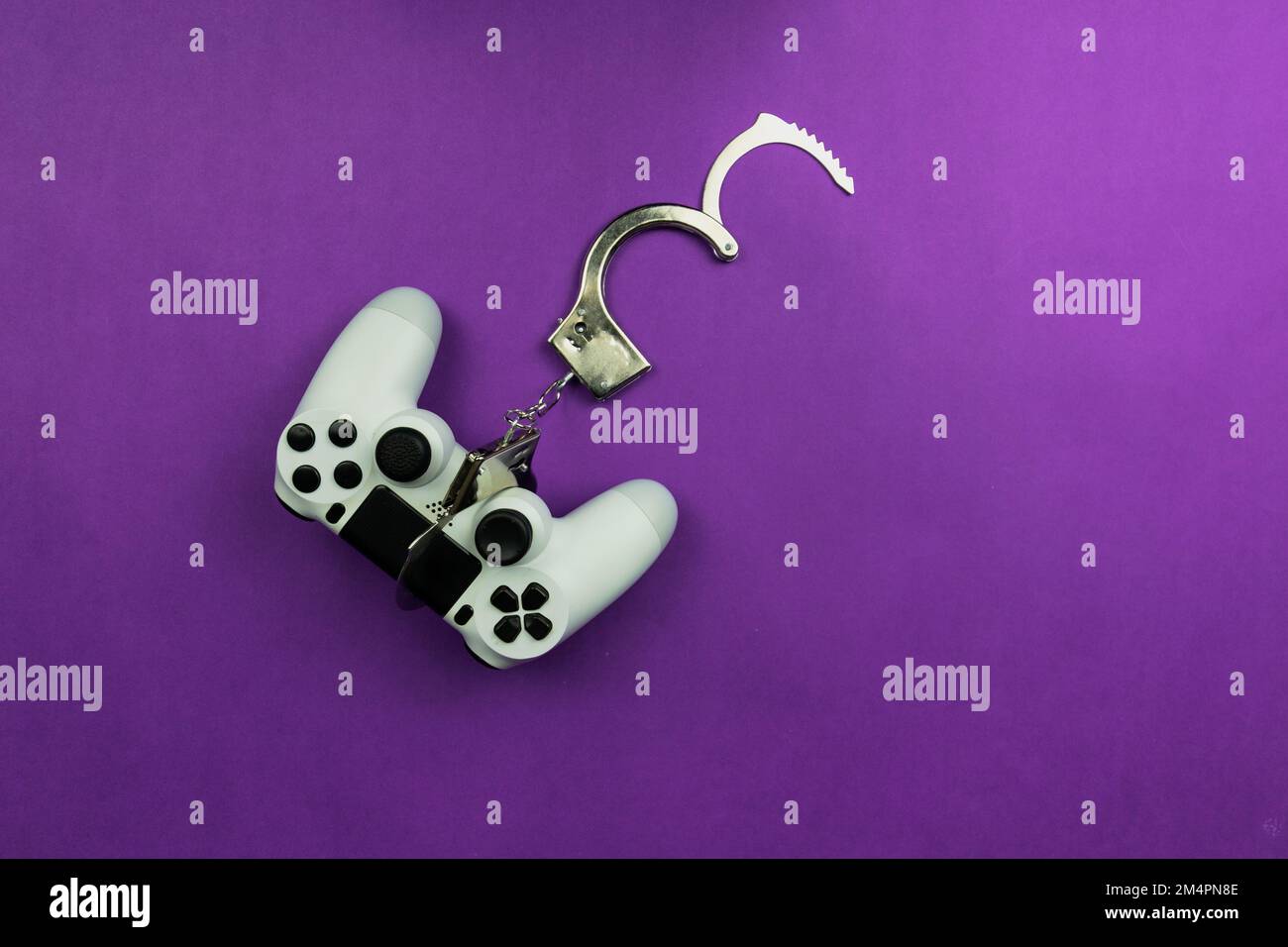 Video game joystick and handcuffs isolated. Addiction to games concept ...
