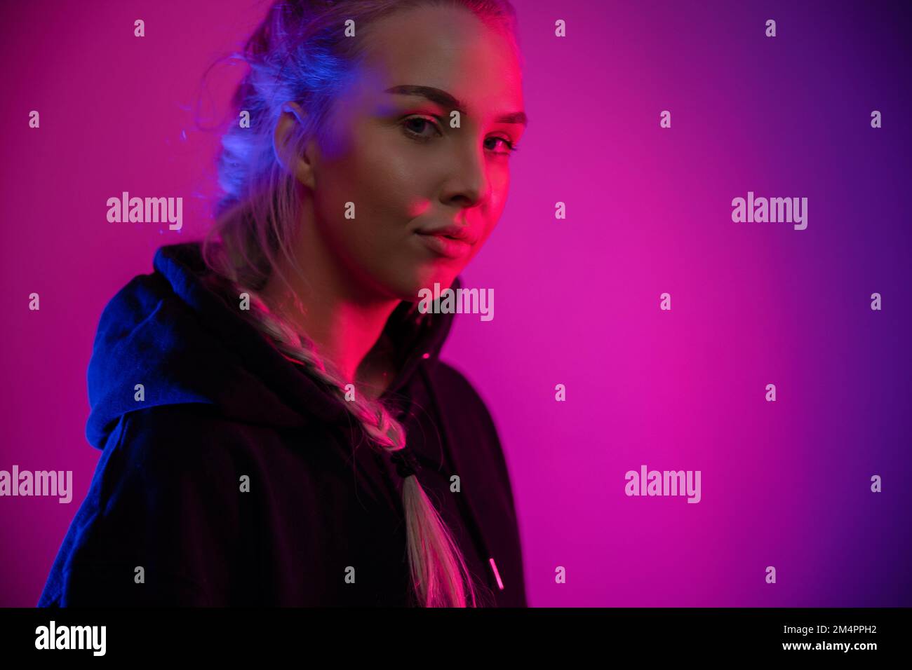 Colorful low-key portrait of a cool and confident blonde woman in ...