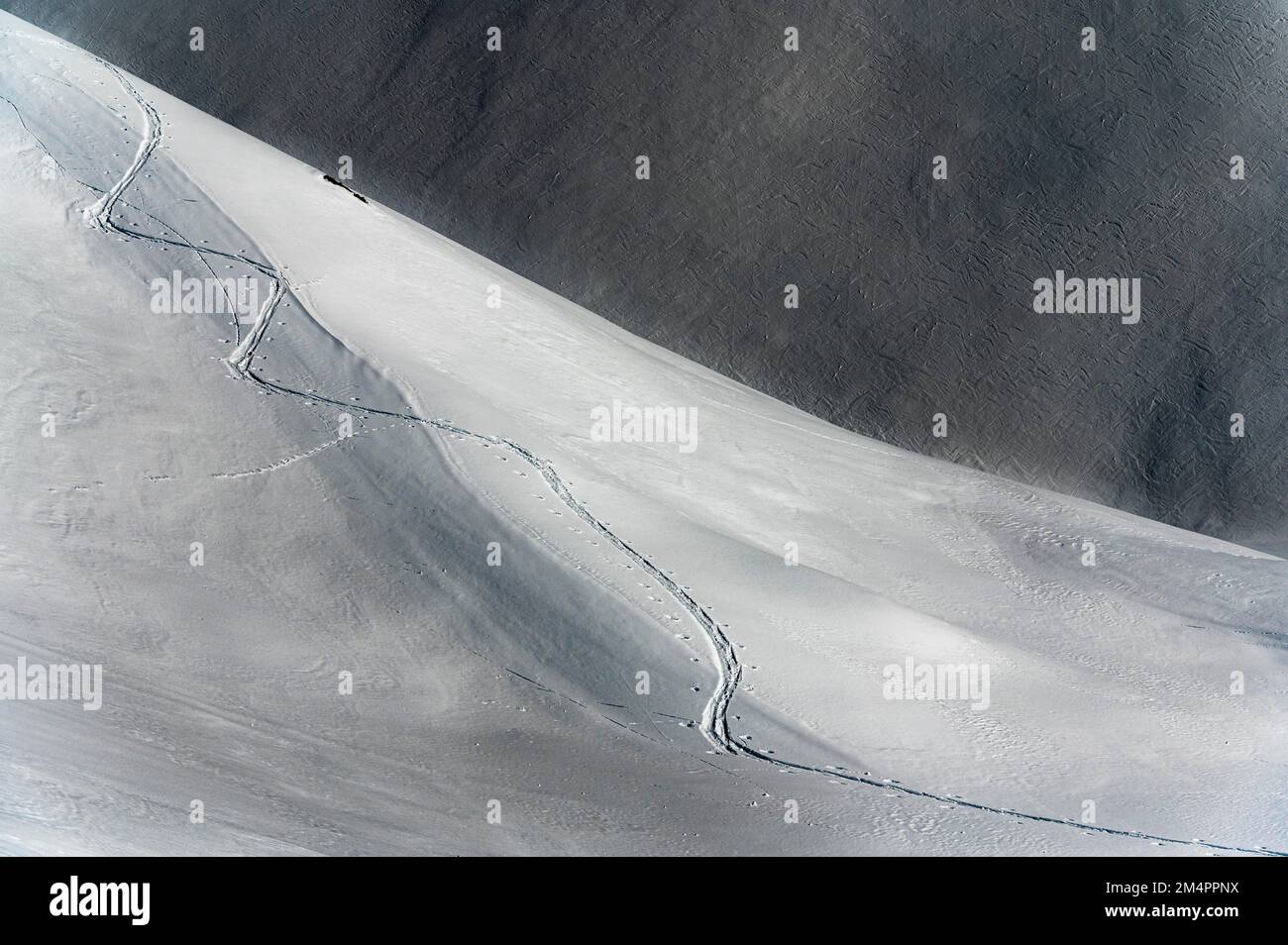 Ski touring trail in deep snowy mountain landscape with light and ...