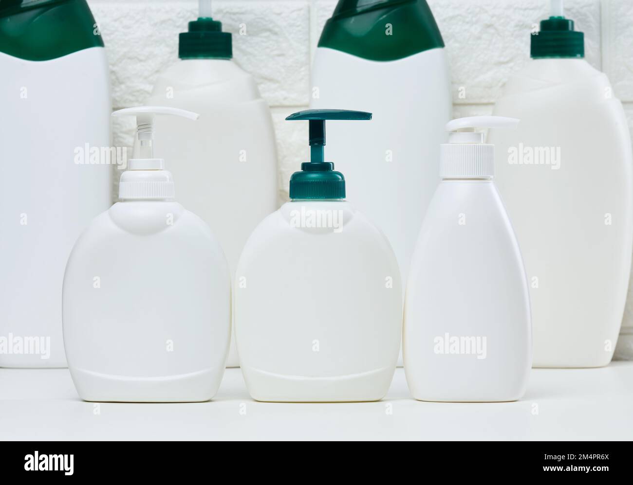 White plastic container with a pump for liquid products on a white ...