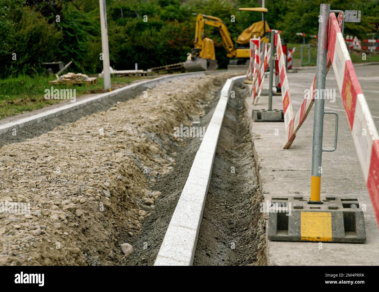 Blocked off construction site with excavator Stock Photo - Alamy