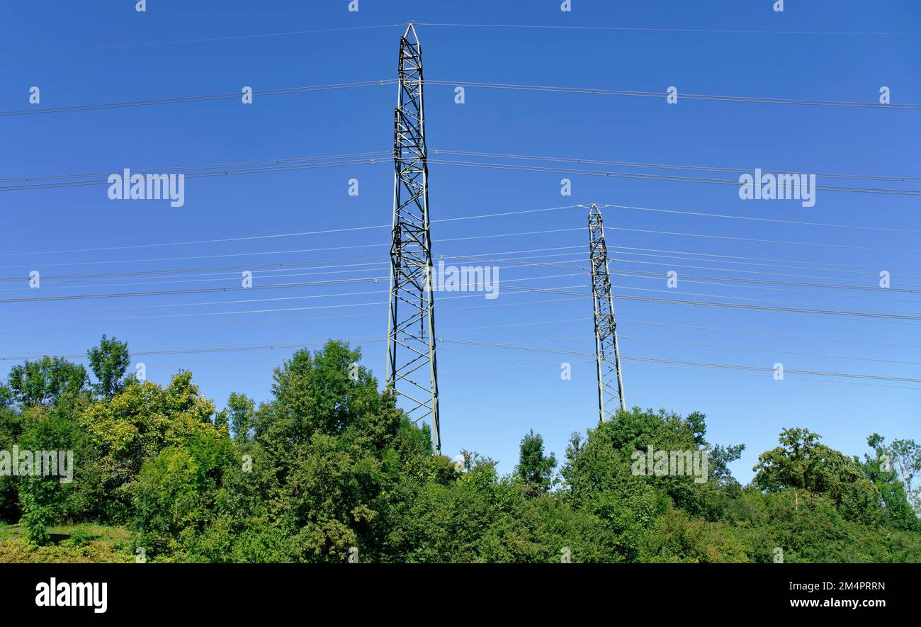Electricity pylons in a green landscape Stock Photo - Alamy