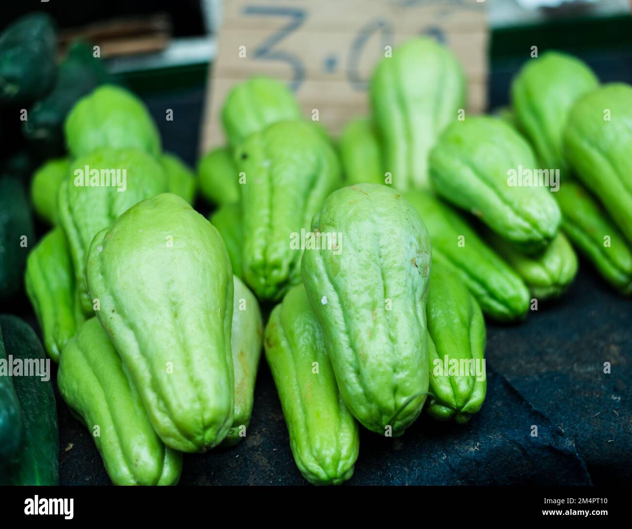 Green chayotes stacked and ready for sale. Organic concept Stock Photo ...