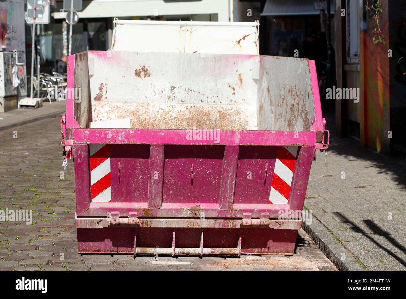 Pink skip for building rubble standing on the road, Germany Stock Photo ...
