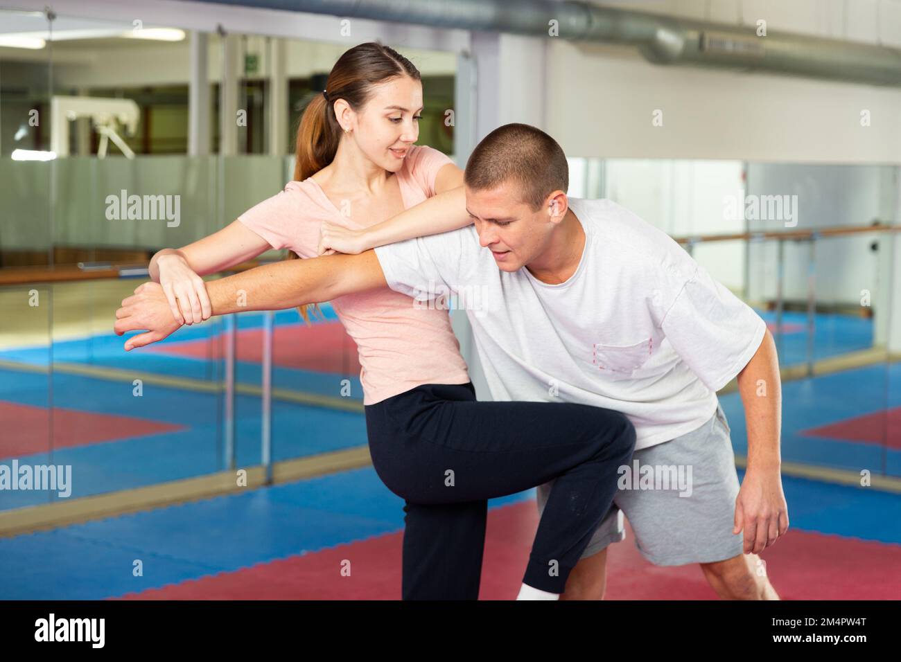 Active girl conducts painful grip on self-defense training in gym Stock ...