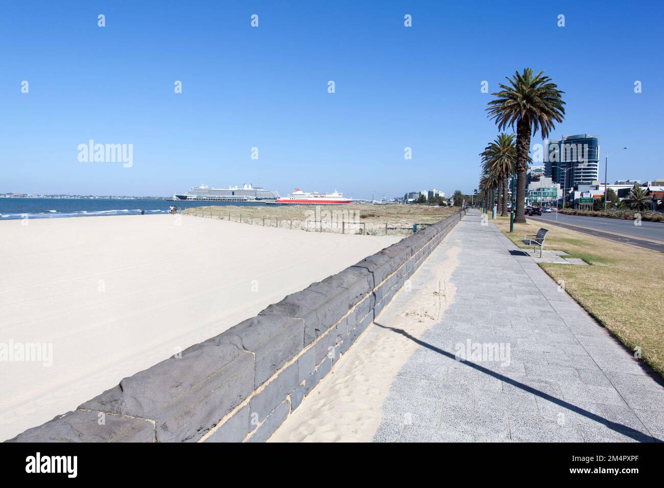 The view of an empty Melbourne seaside road and a beach with a ferry ...