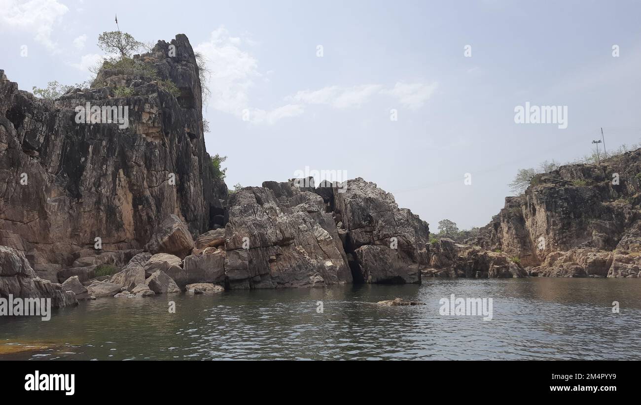 A beautiful nature scene with the cliffs and lake under a blue sky ...