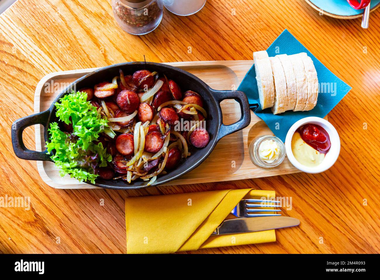 Grilled sausages with onions Stock Photo - Alamy