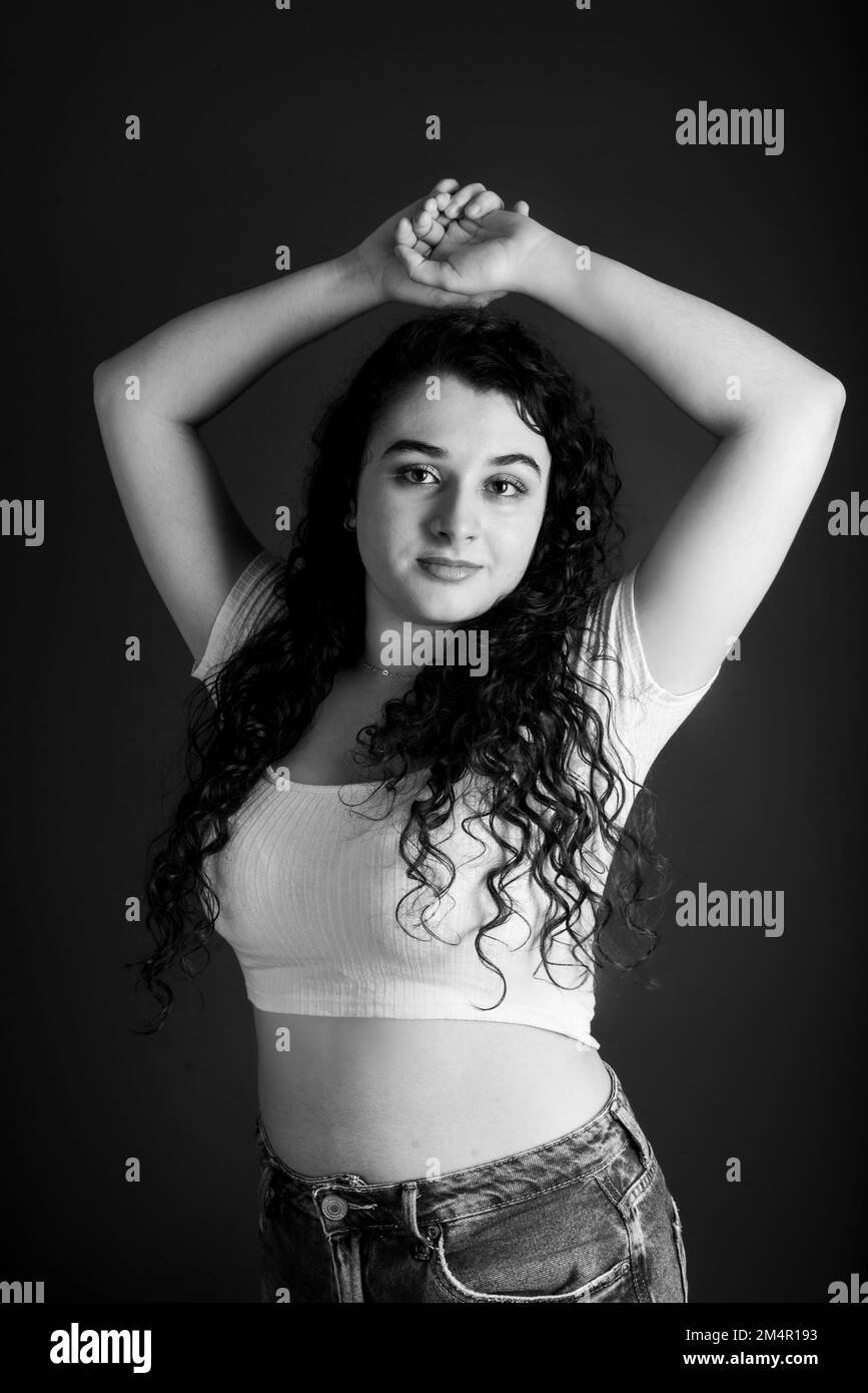 Black and white portrait of cheerful beautiful young woman with hands ...