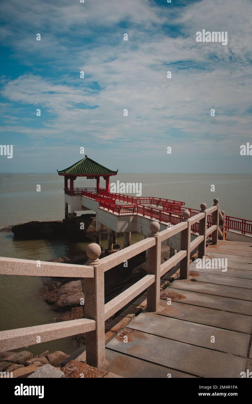 the Dragon claw rock and boulders near a pier at sea Stock Photo - Alamy