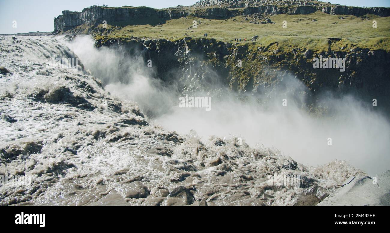 Powerful Dettifoss waterfalk, Riging river water running over the cliff ...