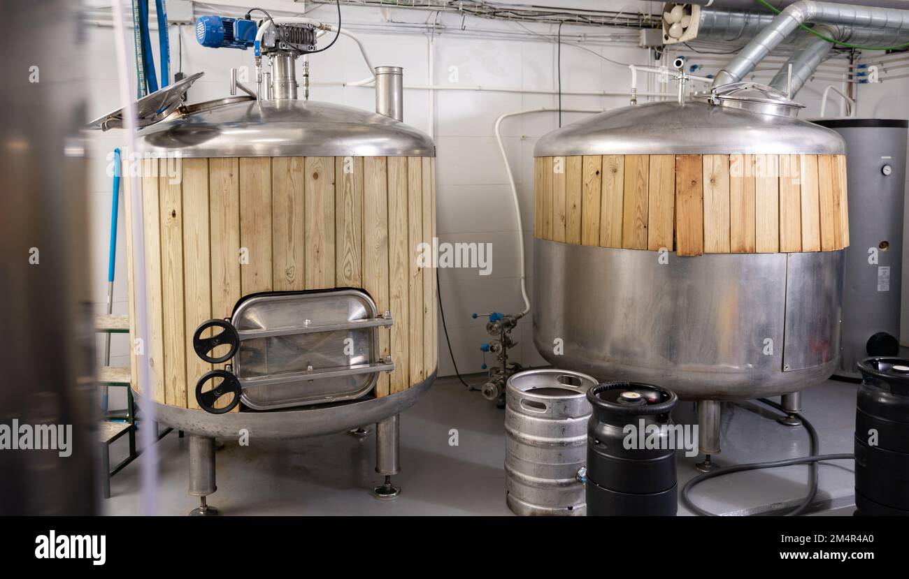 Beer tanks and barrels in brewery Stock Photo - Alamy