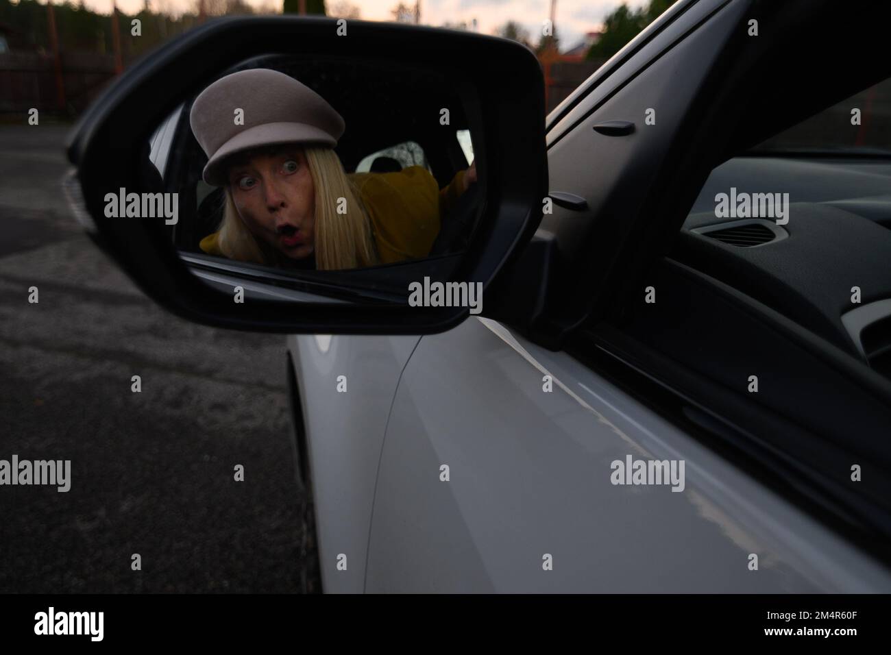 Woman with a surprised funny face looking into the side window Stock ...
