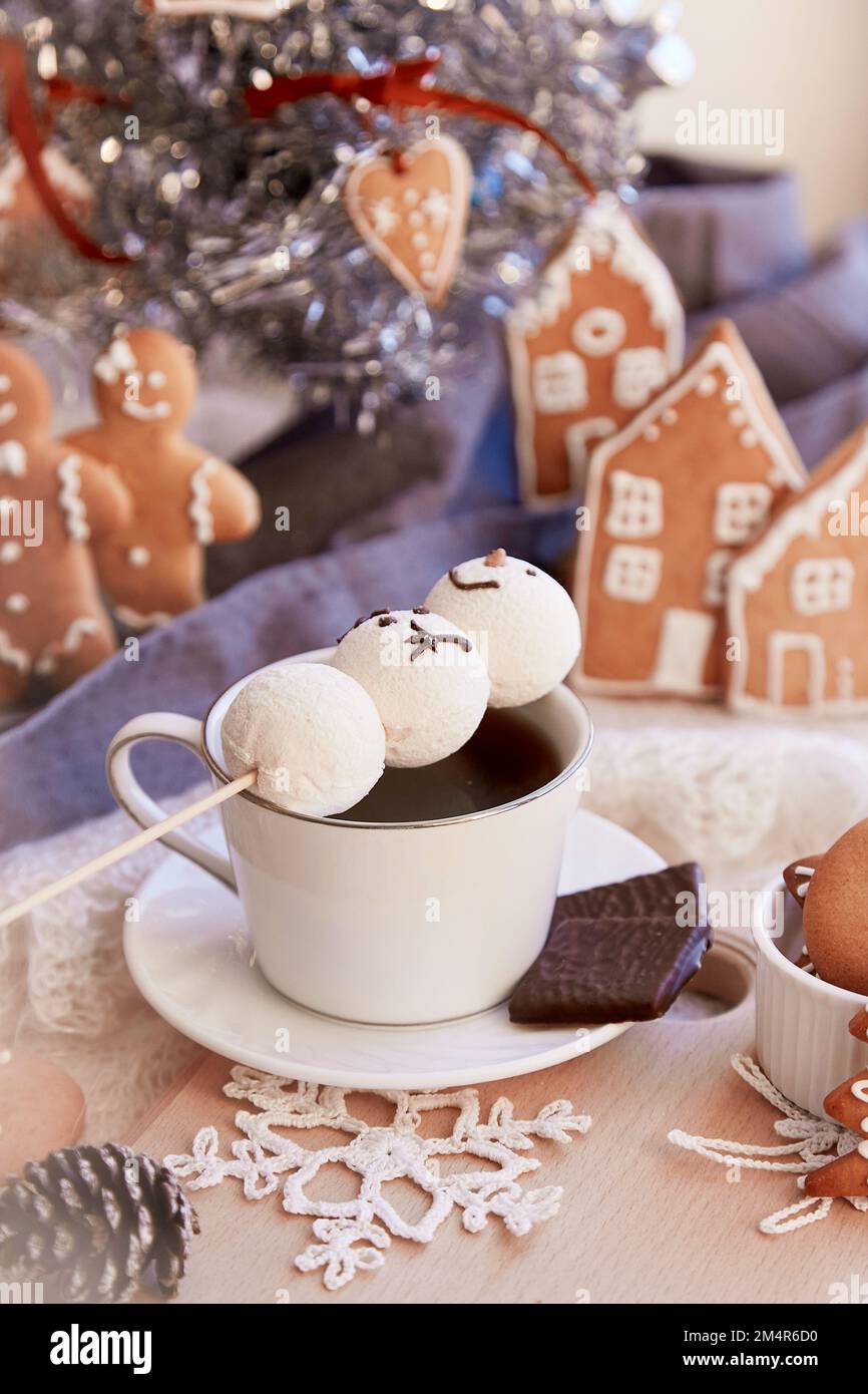 Aesthetic winter breakfast. Cute lying down marshmallow snowman in hot ...