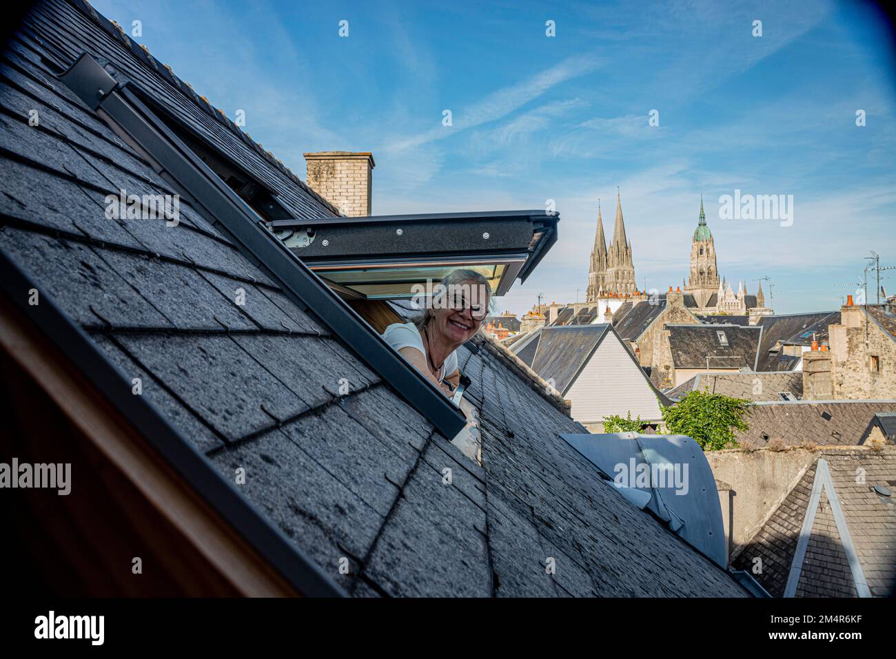 Woman looking out of skylight hi-res stock photography and images - Alamy