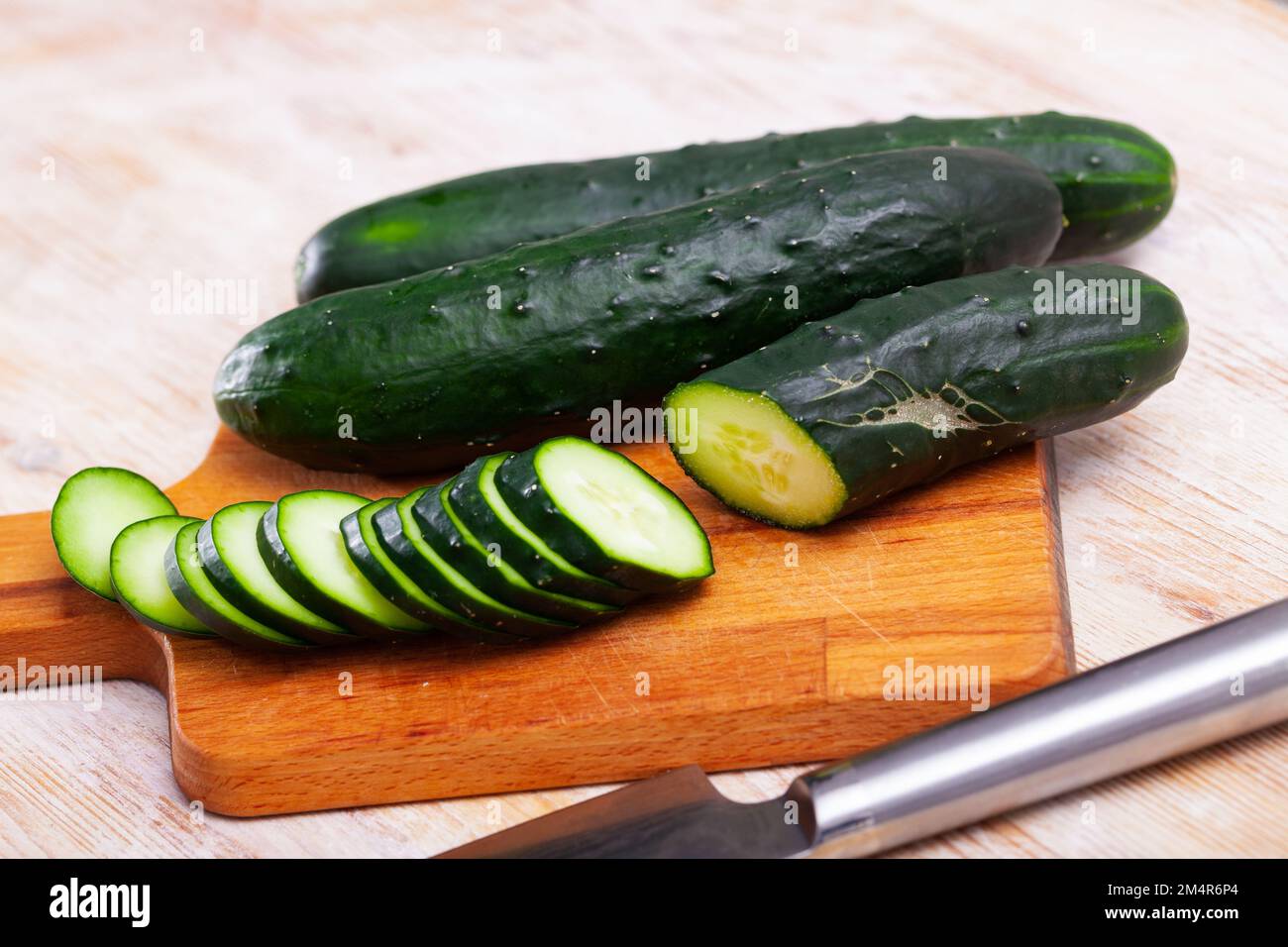 Whole and sliced fresh cucumbers Stock Photo - Alamy