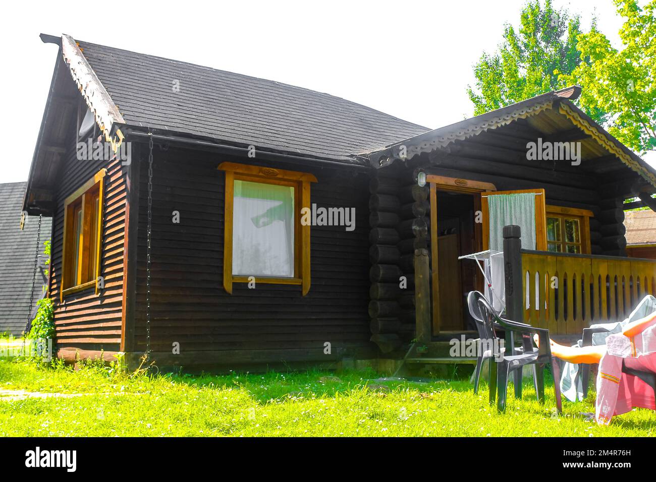 Brown vacation cottage house made of wood in nature forest in Hemmoor ...