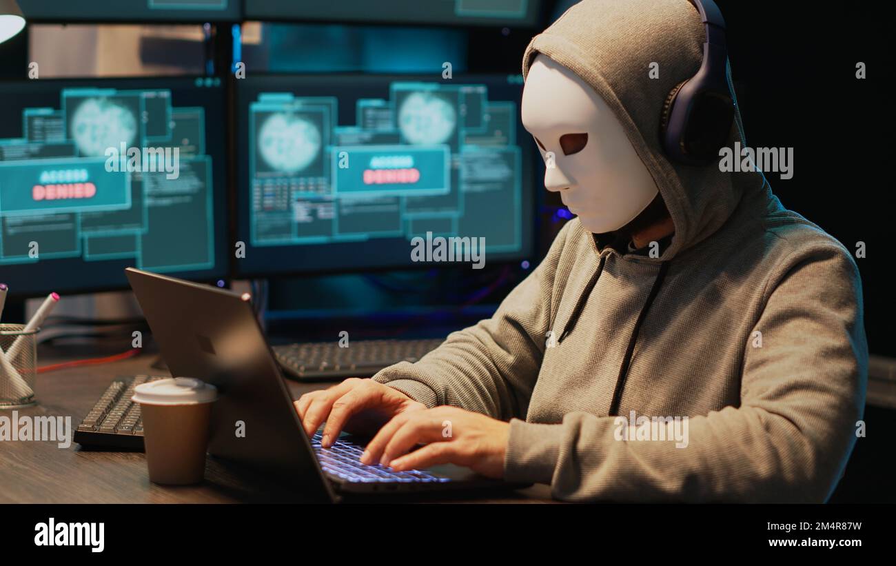 Male Masked Scammer Stealing Information From Database Program Hacking Computer Hardware System