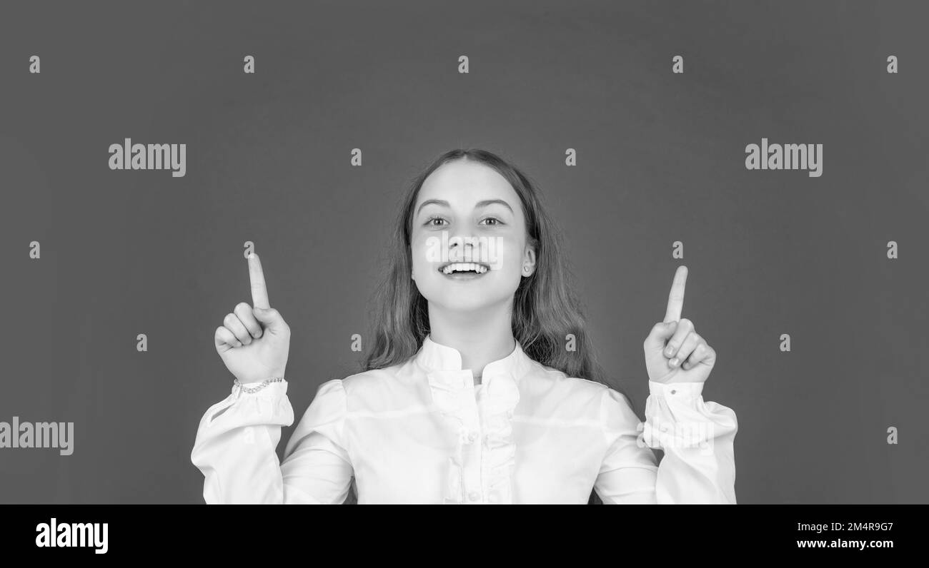kid in white shirt raised fingers up on red background. childhood ...