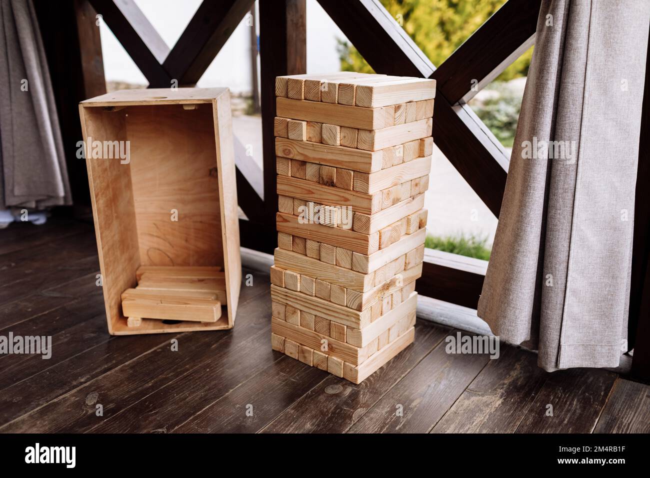 Jenga, multistory tower of wooden blocks. Group game of physical skill ...