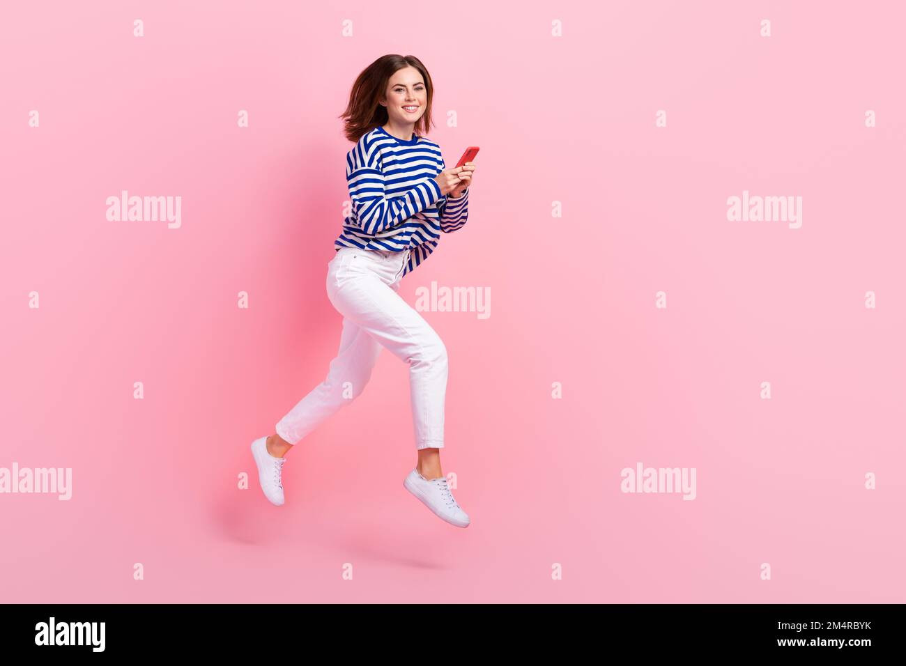 Full length photo of excited energetic person jumping rush hold use ...