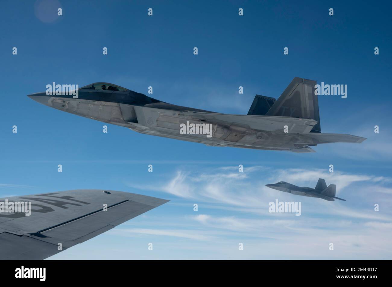 U.S. Air Force F-22 Raptors fly alongside a KC-135 Stratotanker during ...