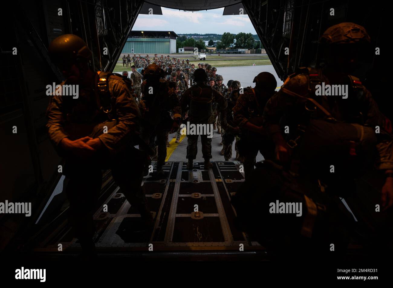 Members of the U.S. and German militaries board a U.S. Air Force MC-130 ...