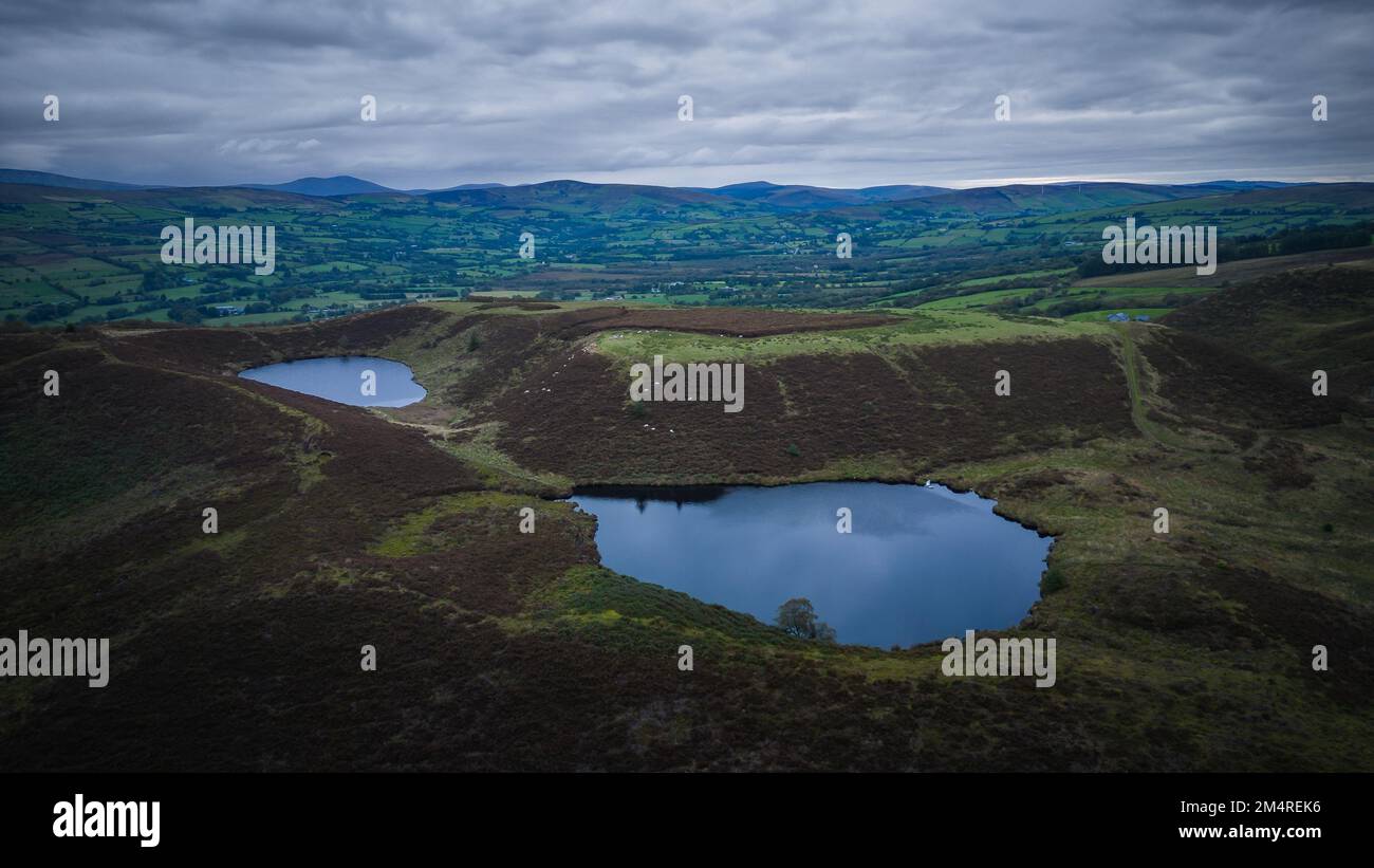 An aerial view of Gortin lakes surrounded by greenery fields Stock ...