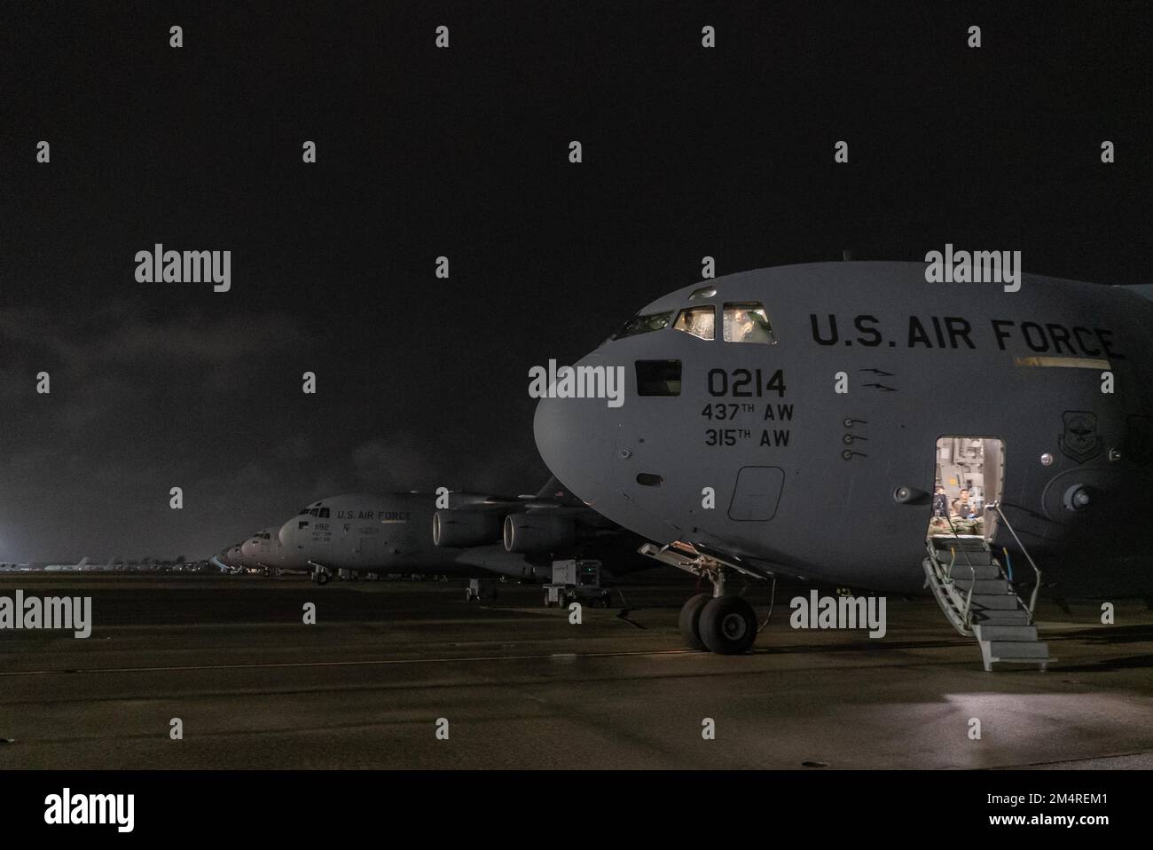 15th Airlift Squadron C-17 Globemaster III aircrew members load their ...