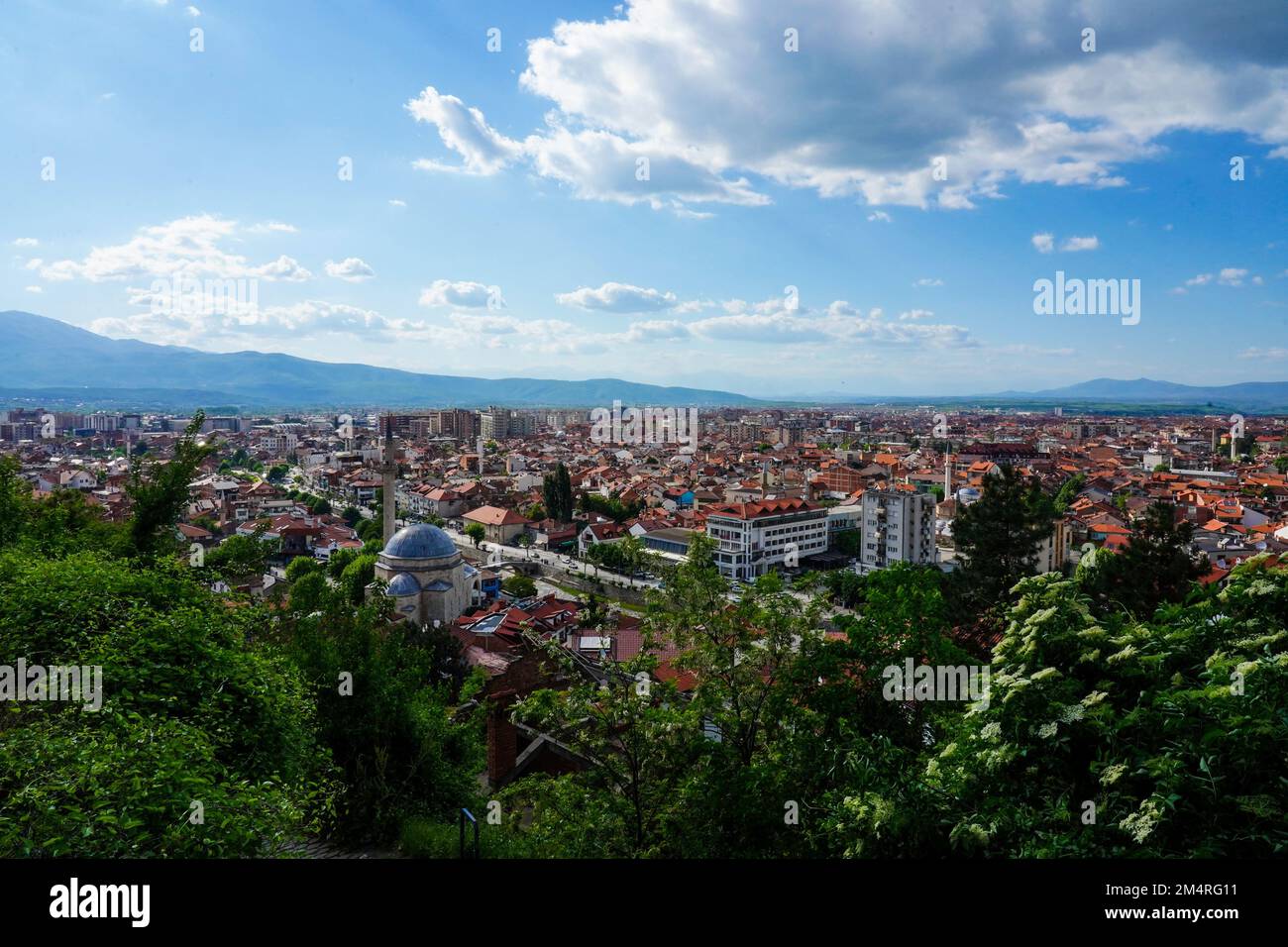 An aerial view of Prizren cityscape with lush green vegetation under ...