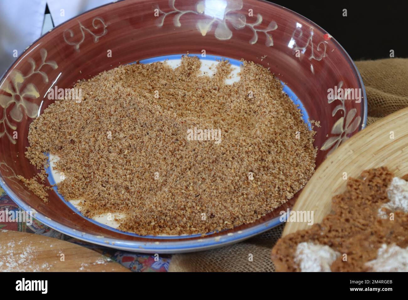 a pot with chopped hazelnuts preparation of sweets Stock Photo - Alamy