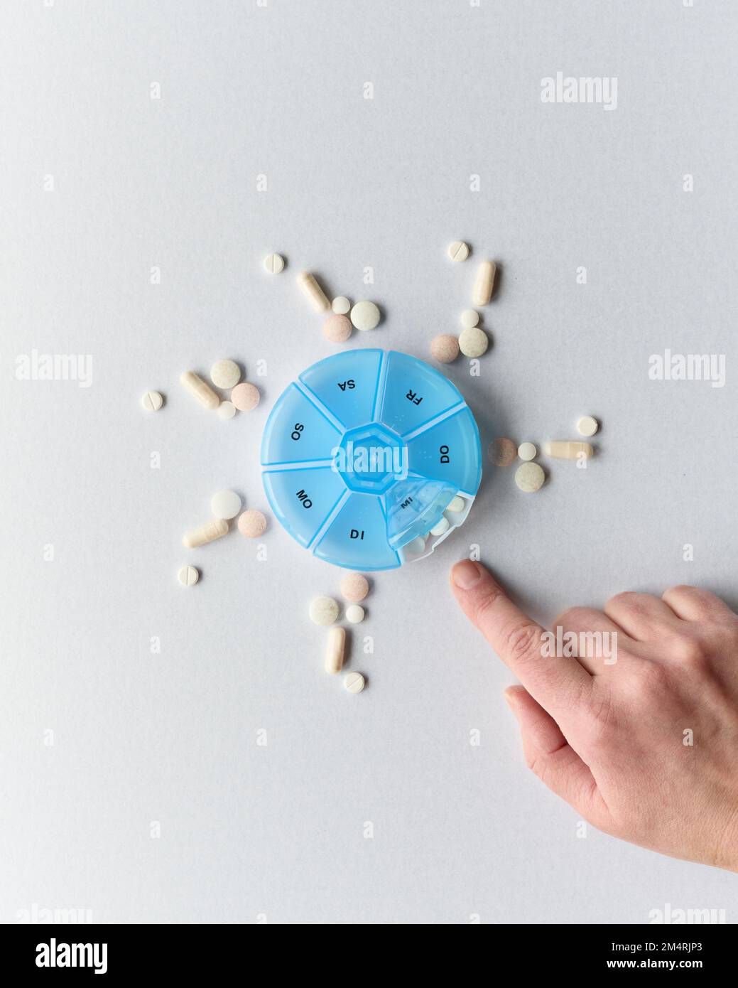 Tablet, pill dispenser and tablets. Flat lay, top view on off white ...