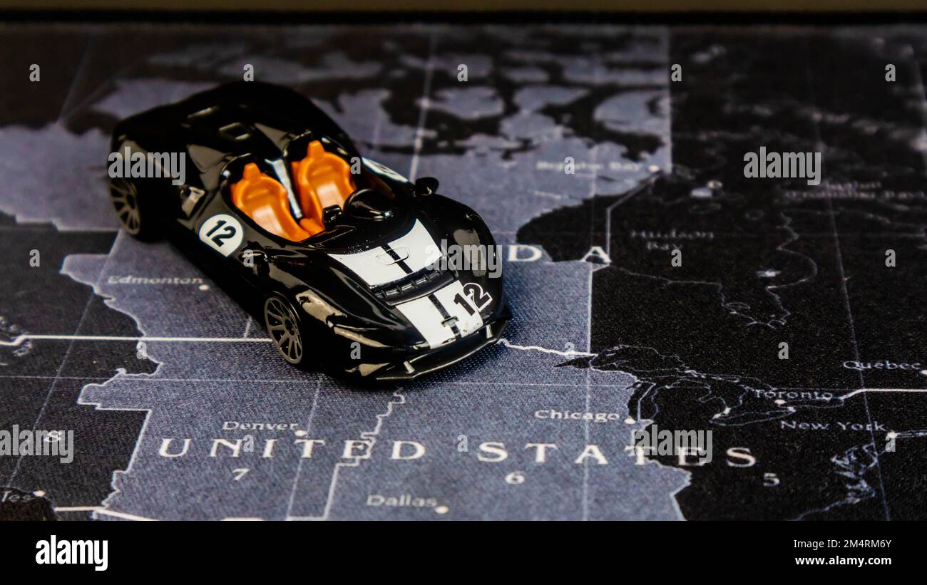 Minahasa, Indonesia : December 2022, a black toy car over the map Stock ...