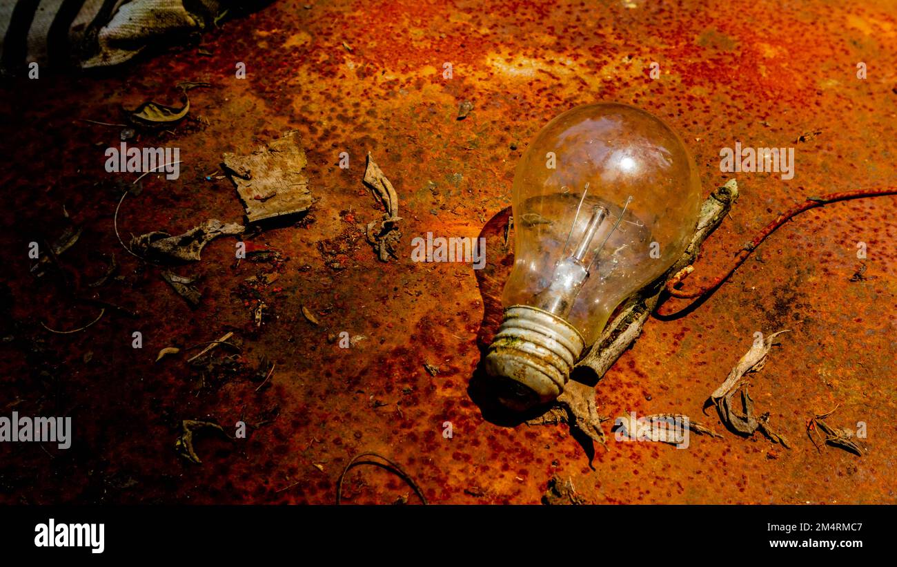 Light bulb on rusty zinc as background Stock Photo - Alamy